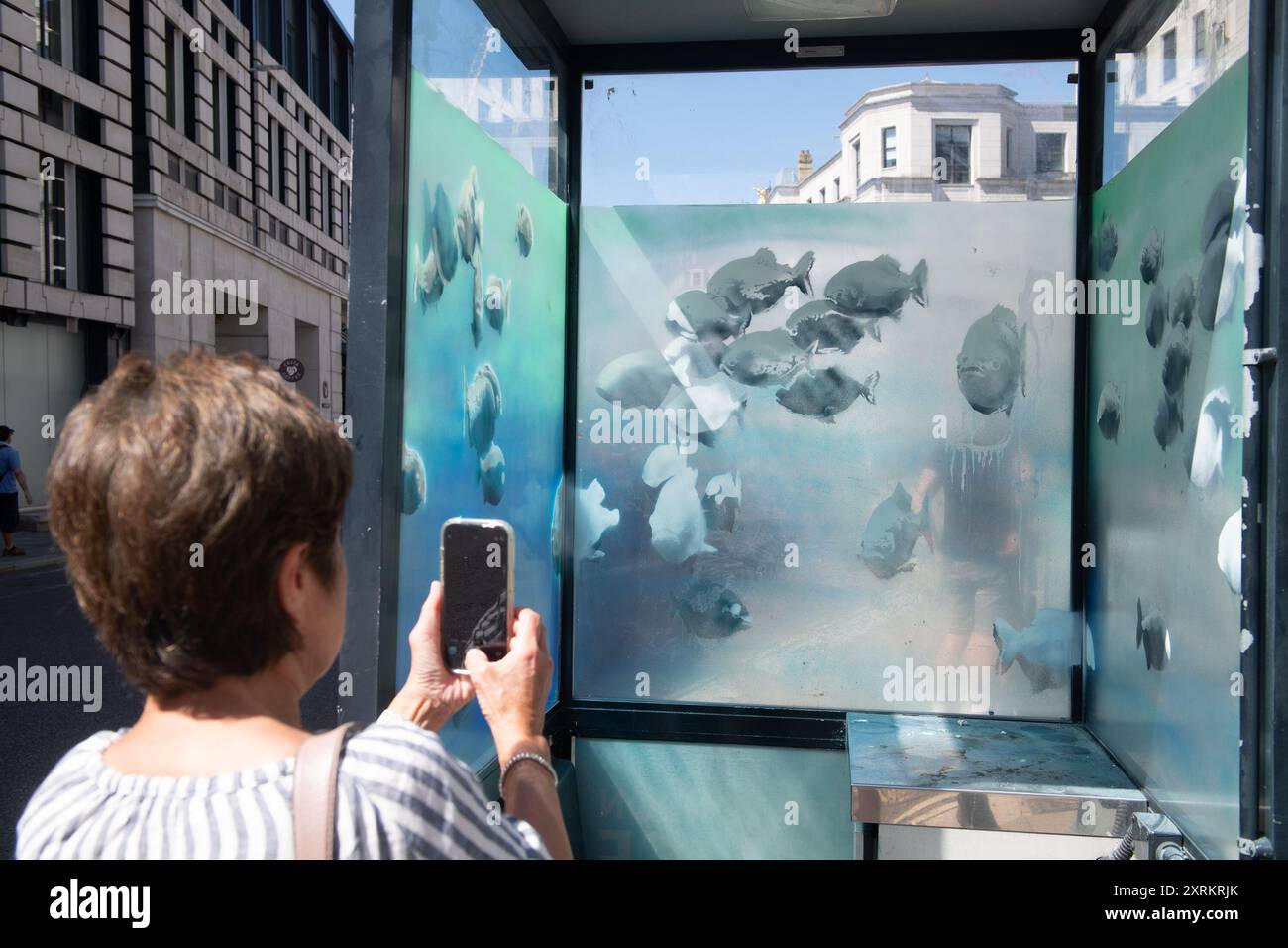 London, UK. 11th Aug, 2024. People take photos of Street Artist Banksy ...
