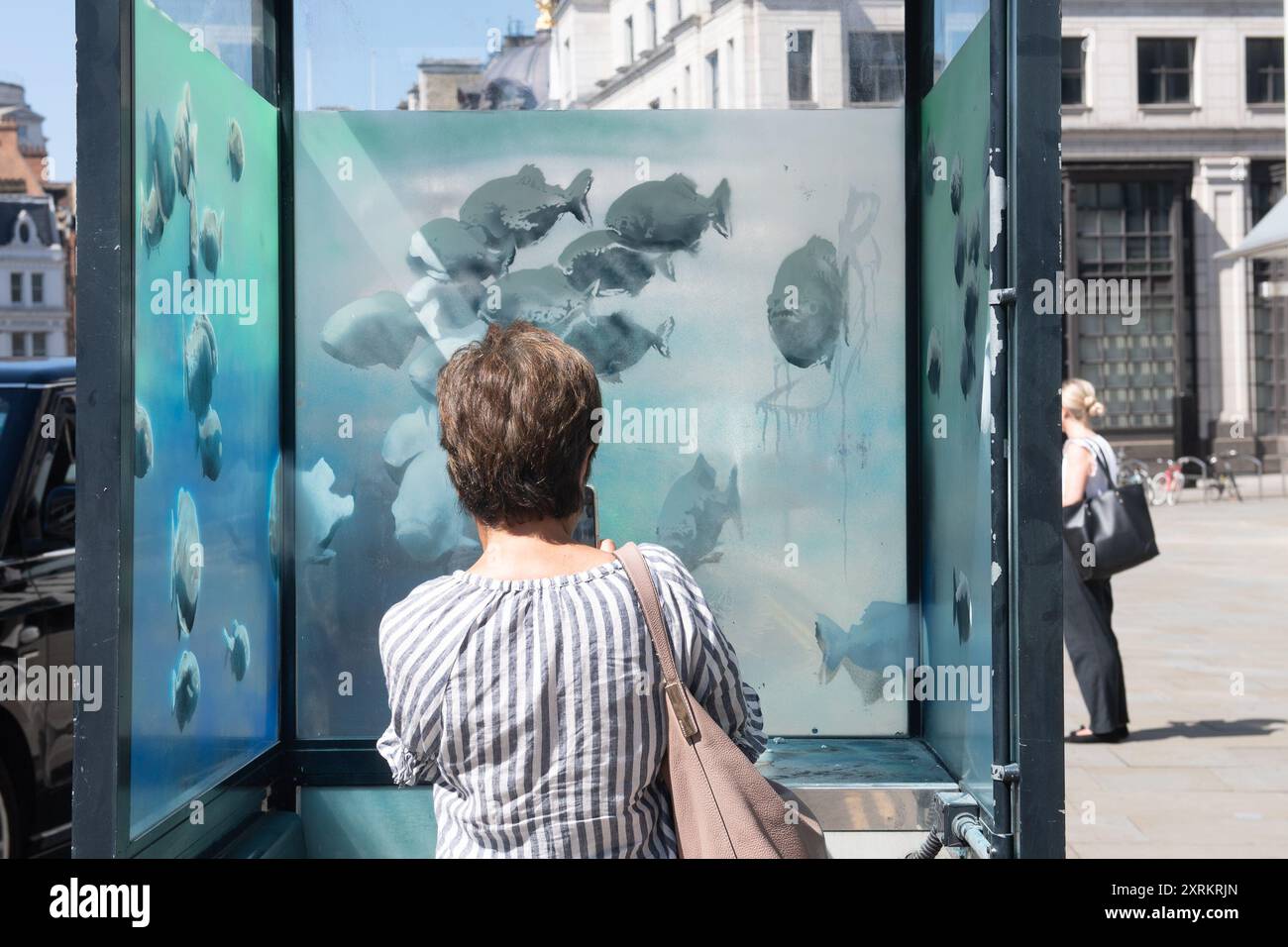 London, UK. 11th Aug, 2024. People take photos of Street Artist Banksy ...