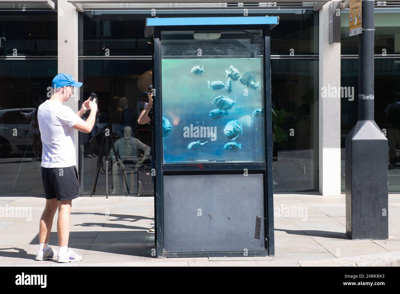 London, UK. 11th Aug, 2024. People take photos of a seventh new mural ...