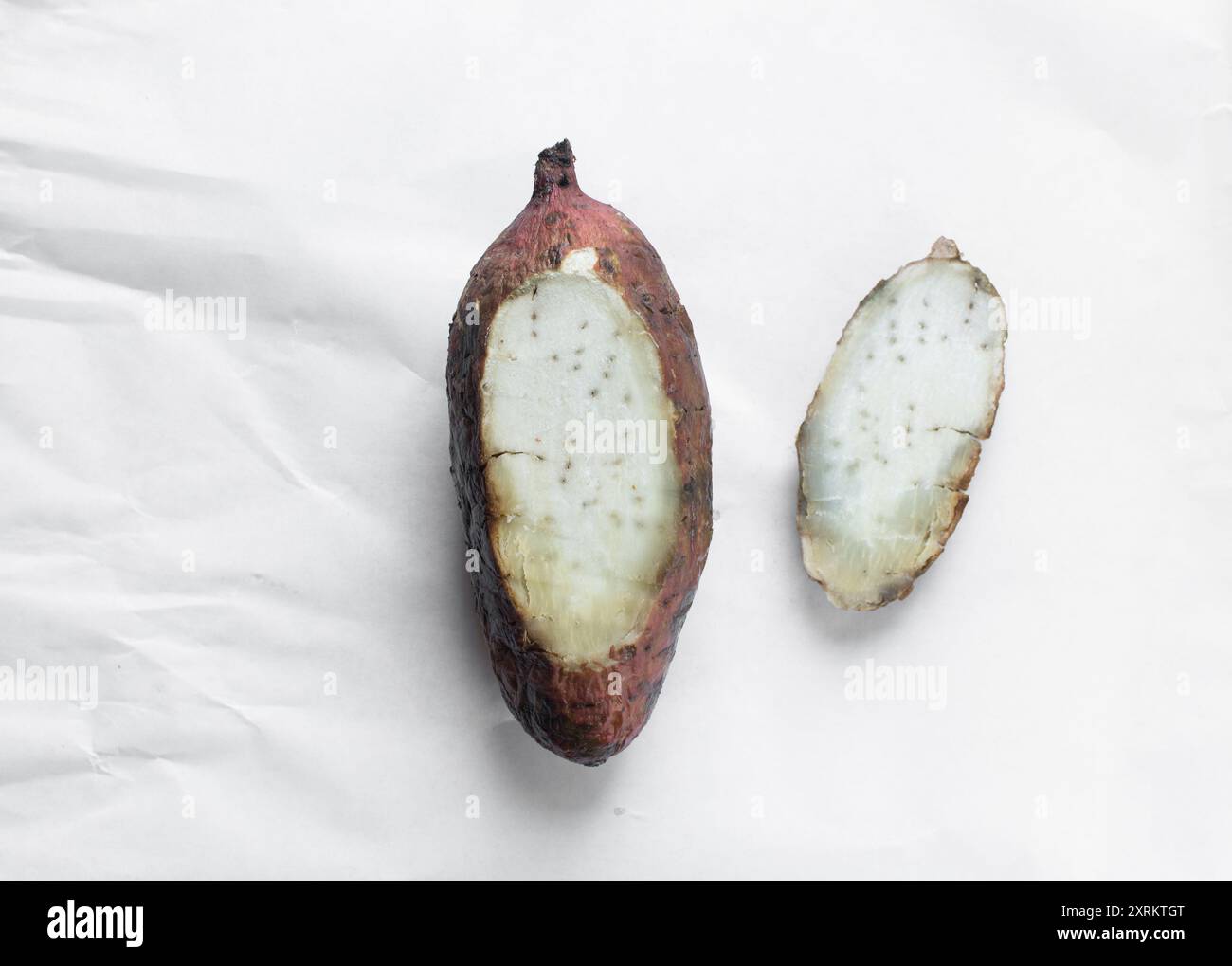 Overhead view of hollowed out roasted sweet potato on a parchment lined ...