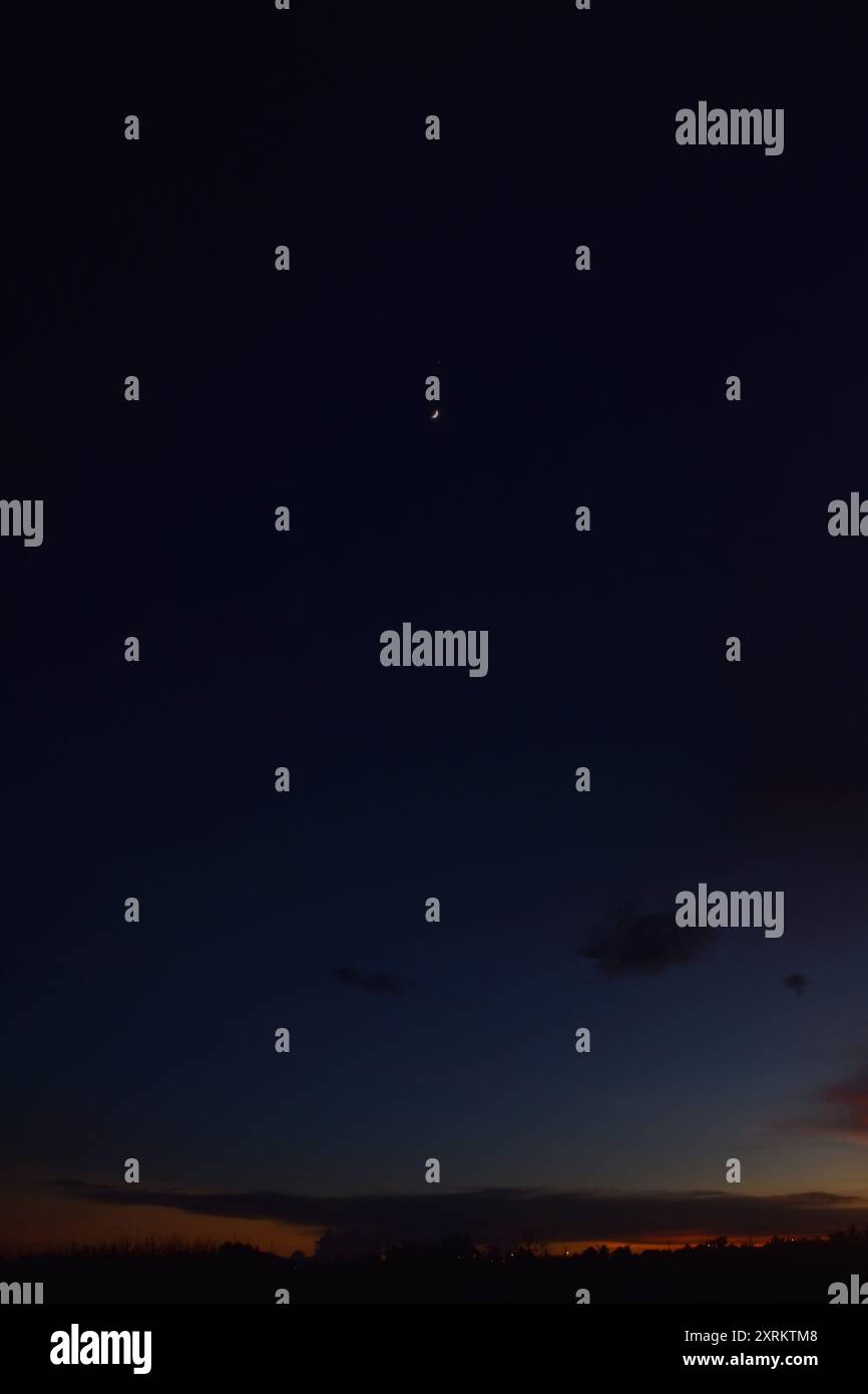 half moon floating on night sky at beach in twilight background Stock ...
