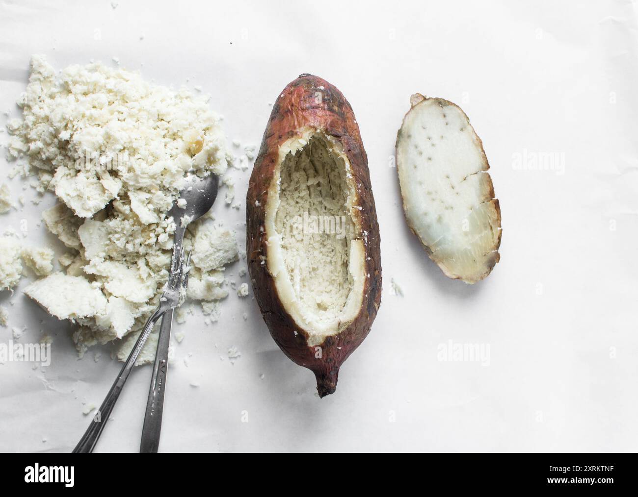 Overhead view of hollowed out roasted sweet potato on a parchment lined ...