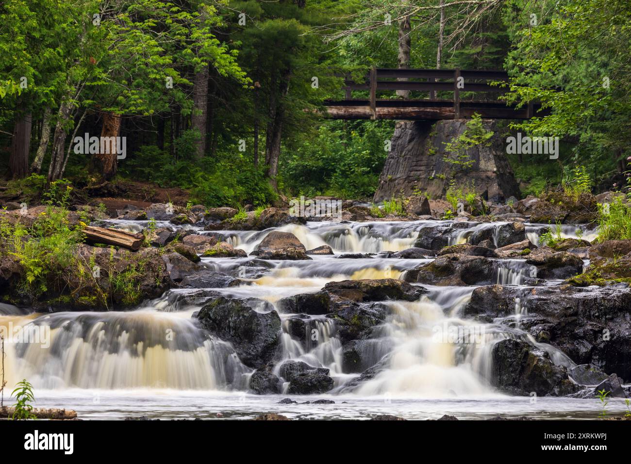 Tyler Forks River Cascades - A cascading waterfall below a footbridge ...