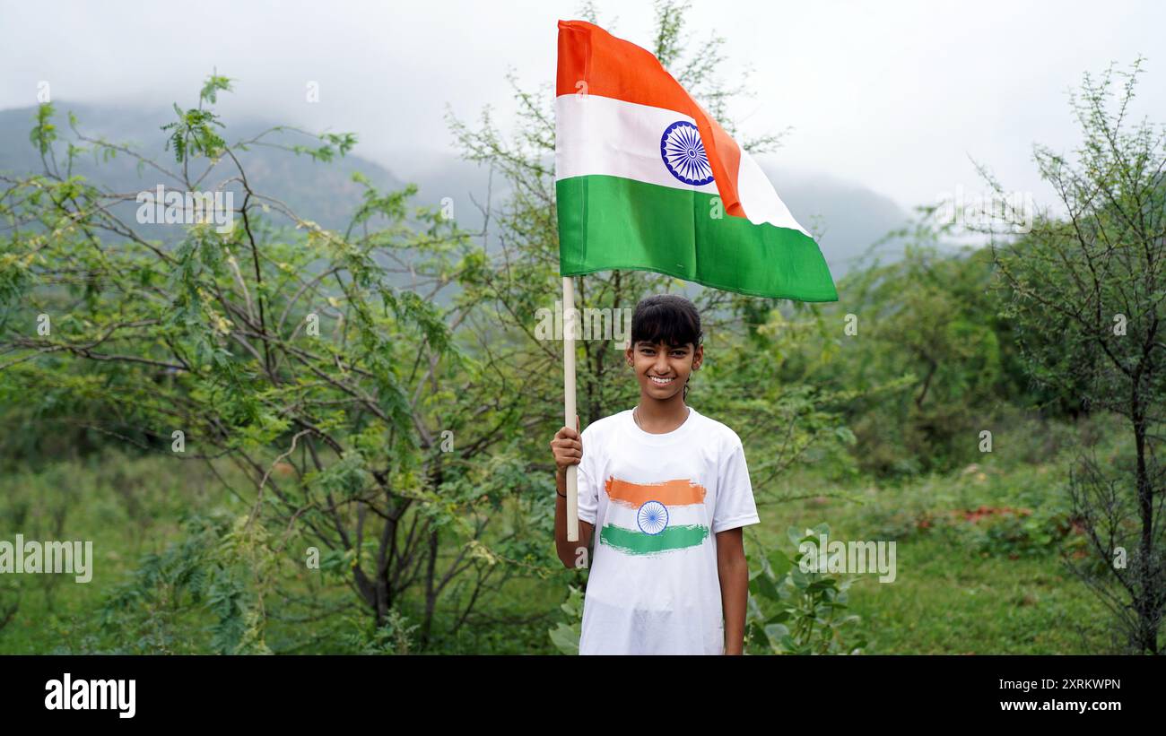 Cute Indian girl holding Indian flag in her hand and smiling ...