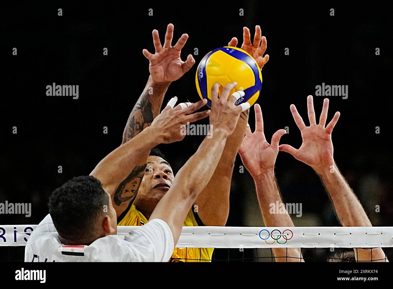 Darlan Ferreira Souza,center, of Brazil, spikes the ball against Egypt ...