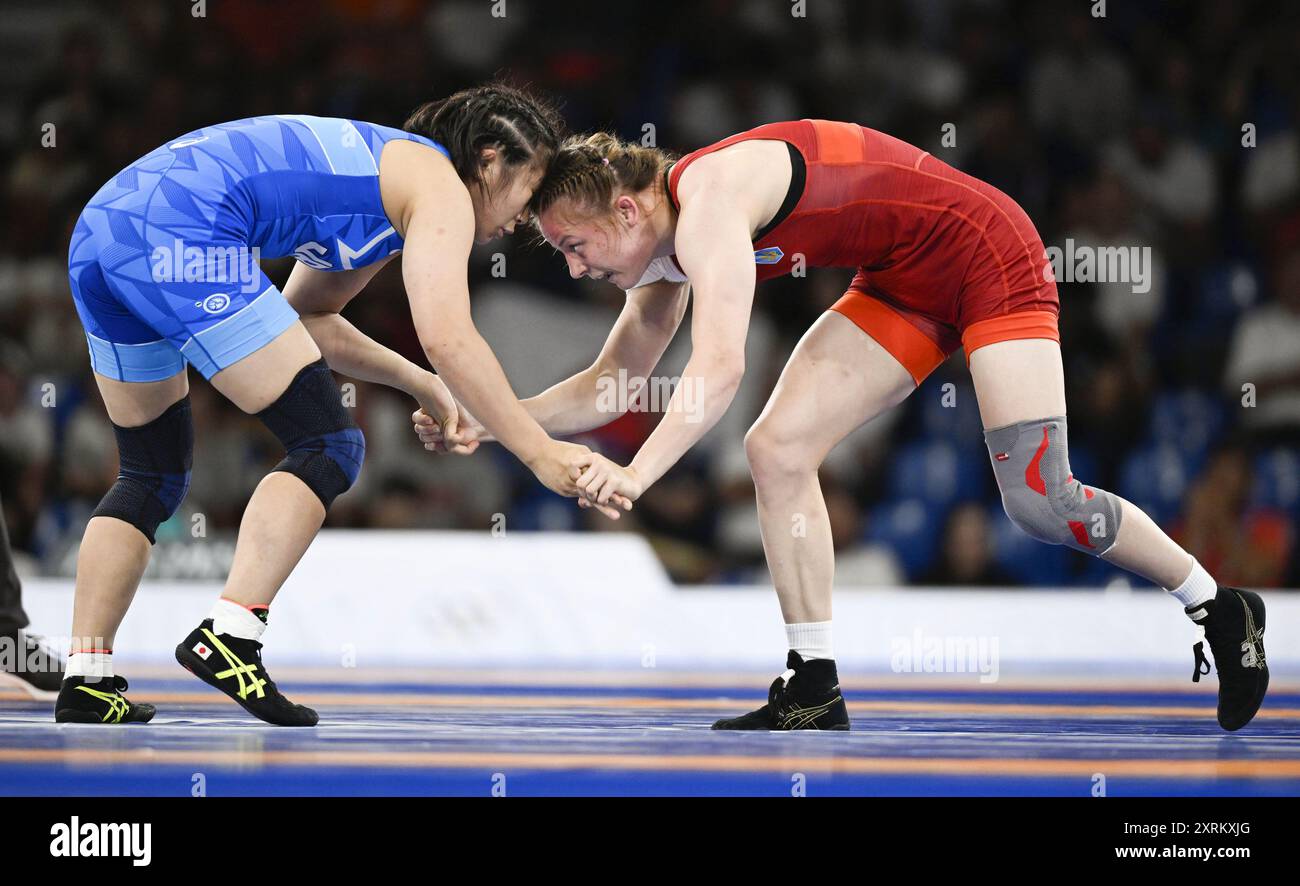 Japan's Sakura Motoki (blue) and Iryna Koliadenko of Ukraine compete in ...