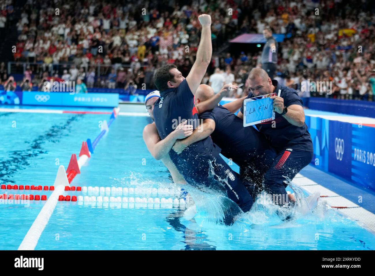 Serbia's head coach Uros Stevanovic is push into the pool as they ...