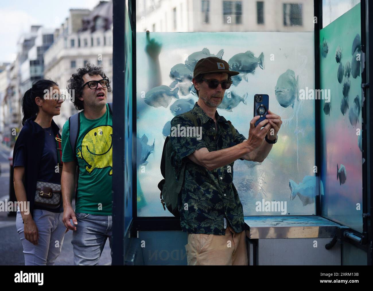A new design of swimming fish by Banksy, has appeared on a police box ...
