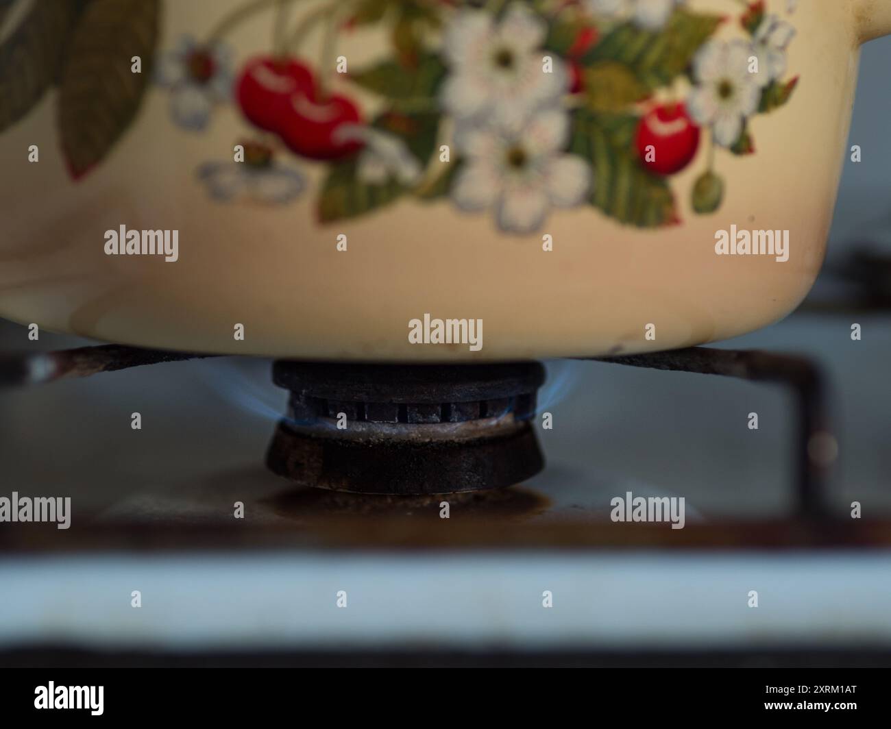 Horizontal Close-Up of a Lit Gas Burner Under a Yellow Cooking Pot with ...