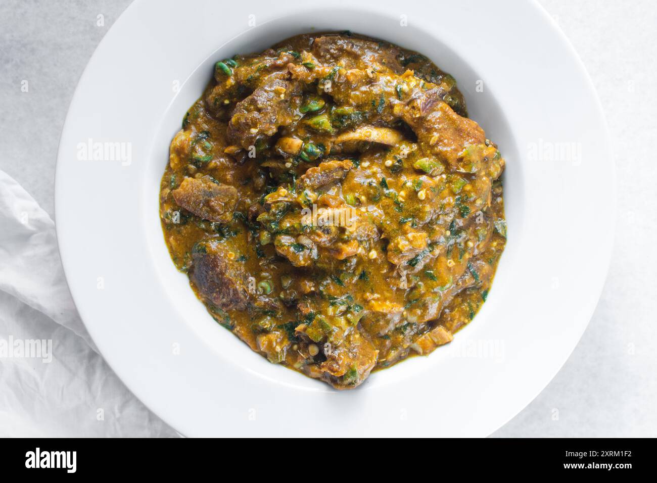 Overhead view of nigerian ogbono soup in a white plate, top view of ...
