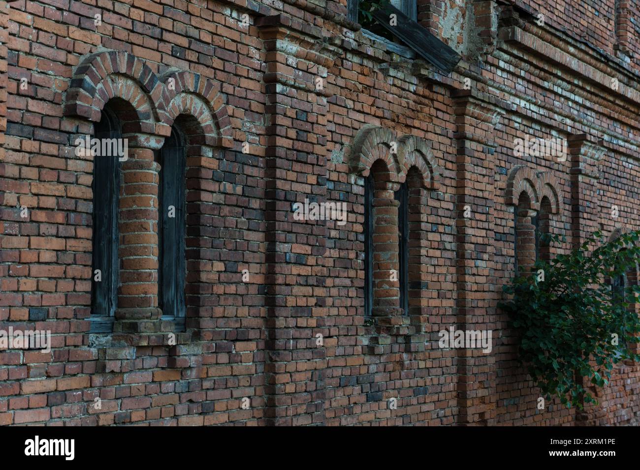 Vertical, narrow windows of a brick stable. 19th century building Stock ...
