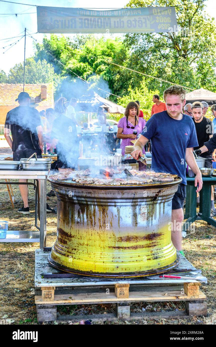 Barbecue food preparation using steel wheel rims for cooking at village ...