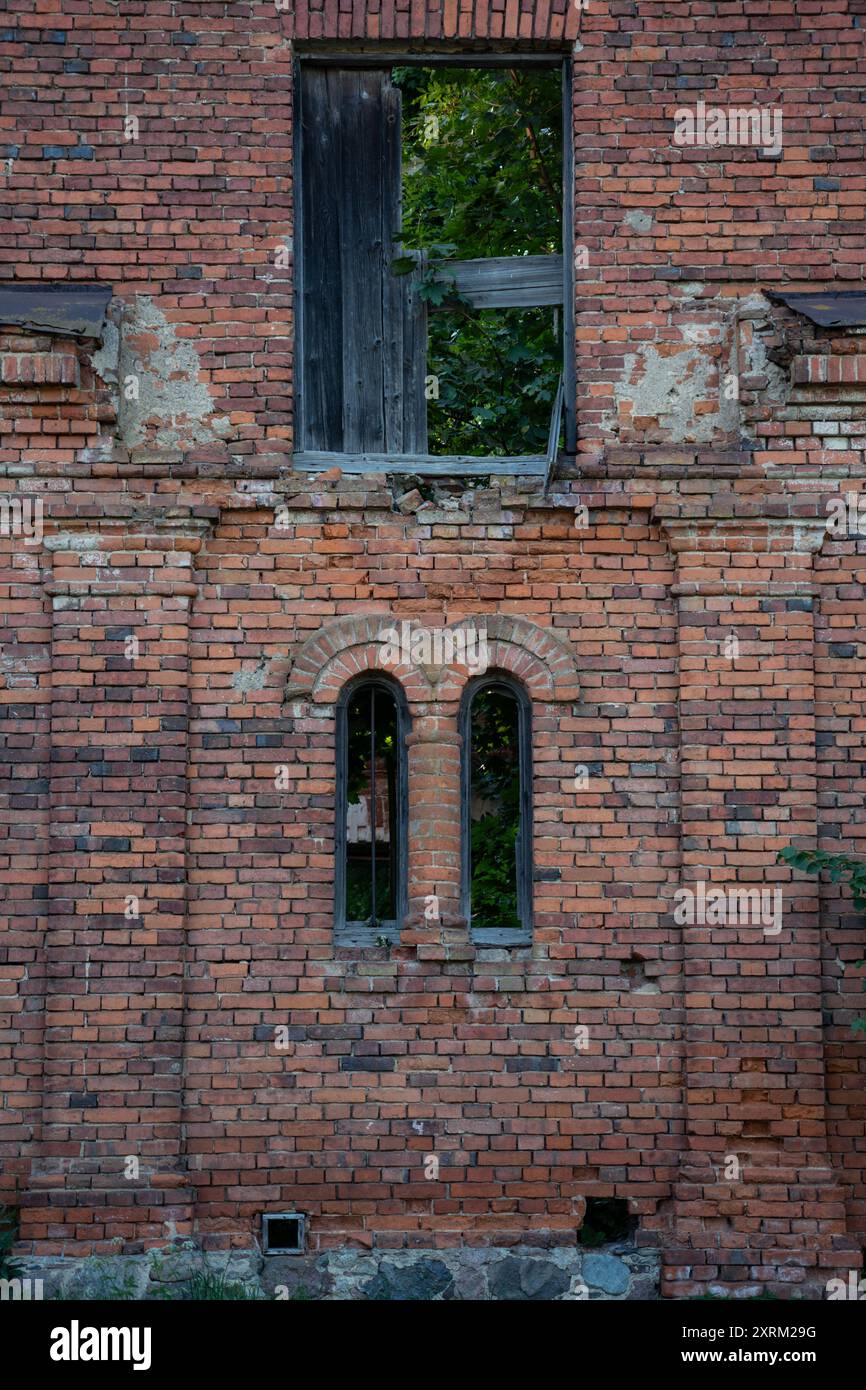 Vertical, narrow windows of a brick stable.19th century buildings Stock ...