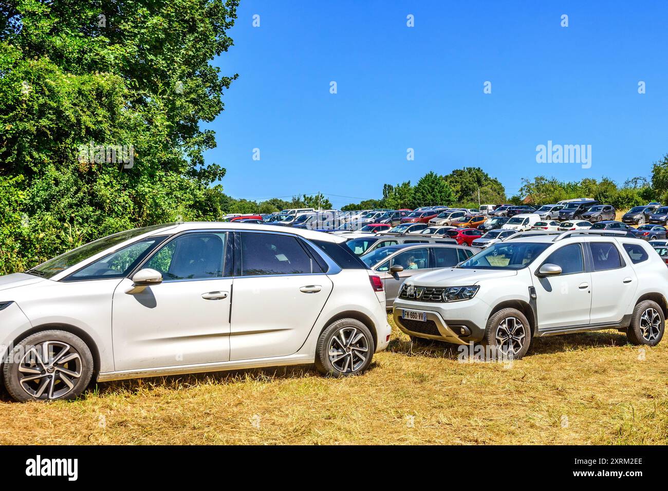 Cars parked on farmland during local country event - central France ...