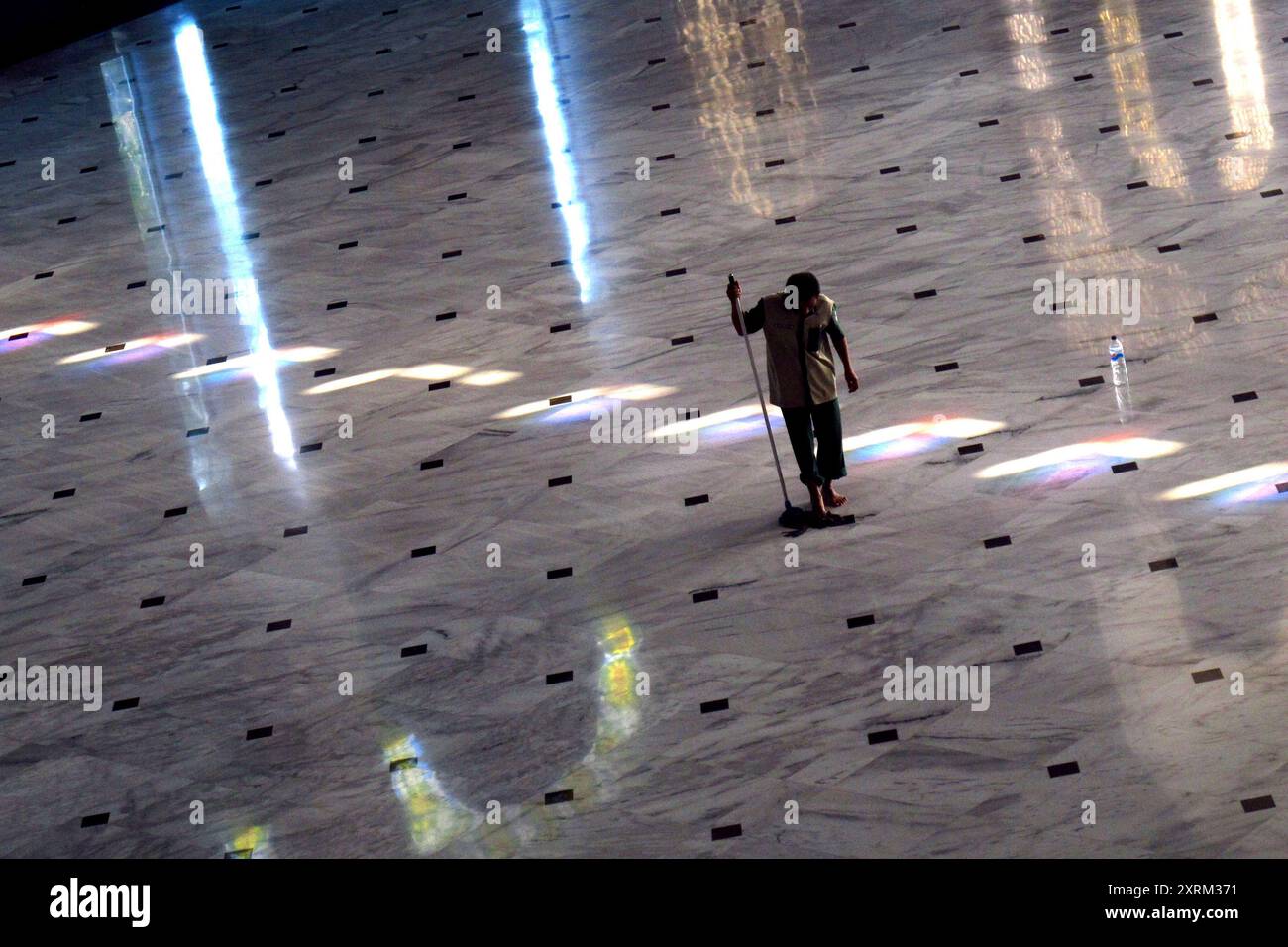 a mosque marbot man is cleaning the mosque floor Stock Photo - Alamy