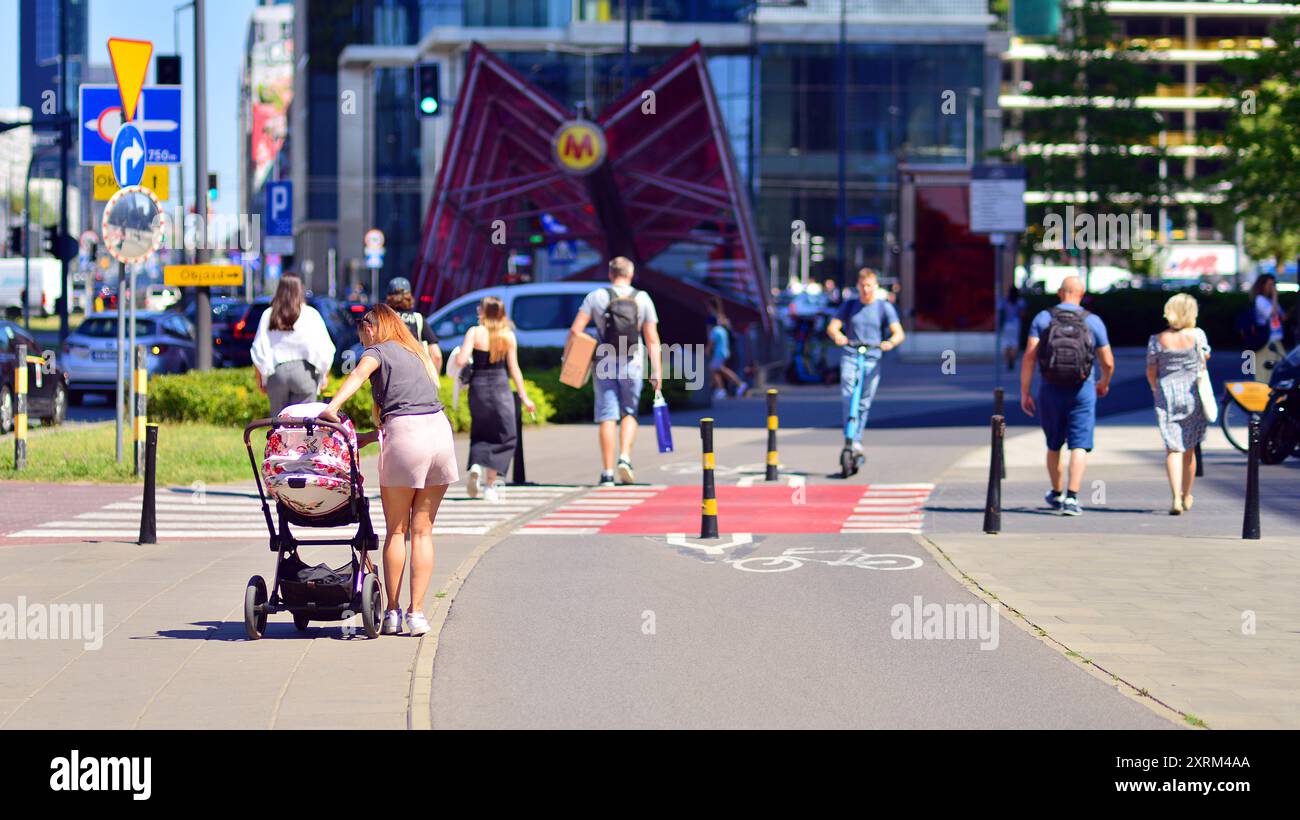 Warsaw, Poland. 31 July 2024. People walking on busy city street on a ...