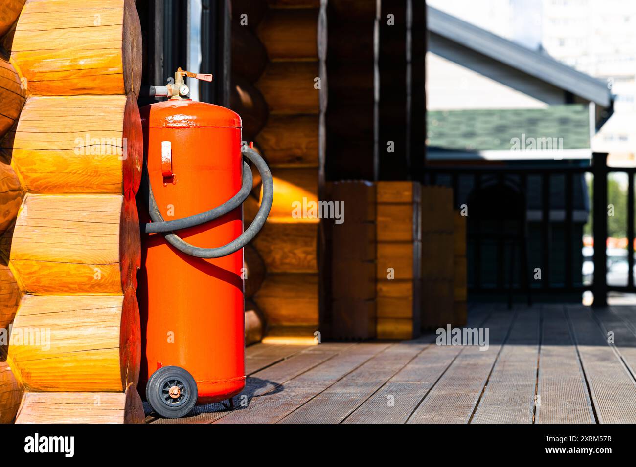 a red mobile fire extinguisher stands near the house Stock Photo - Alamy