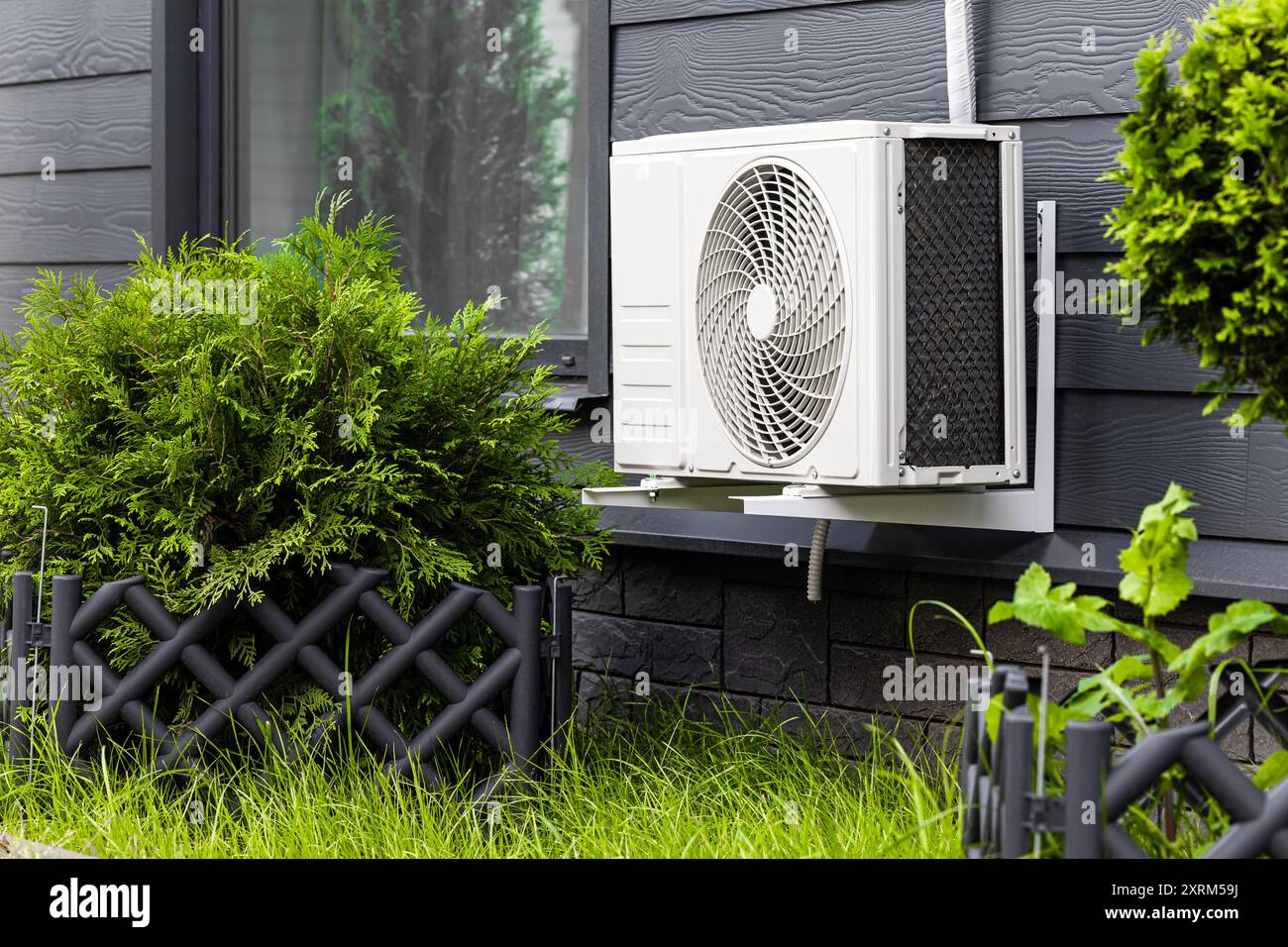 external air conditioner unit mounted on the wall of the house Stock ...