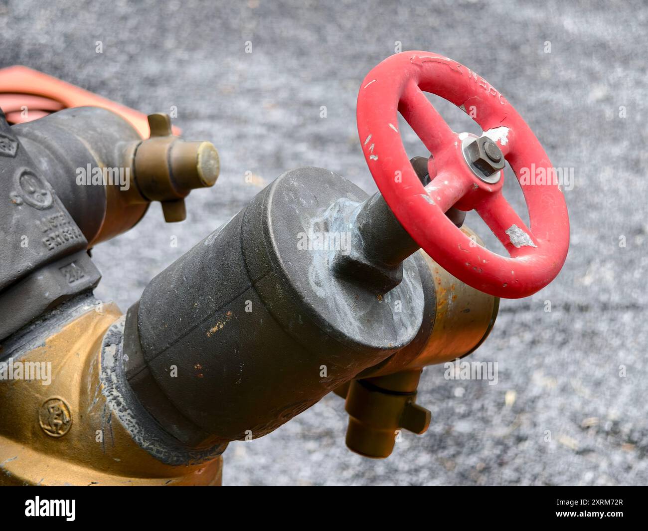 A detailed view of a fire hydrant with vibrant red handles Stock Photo ...