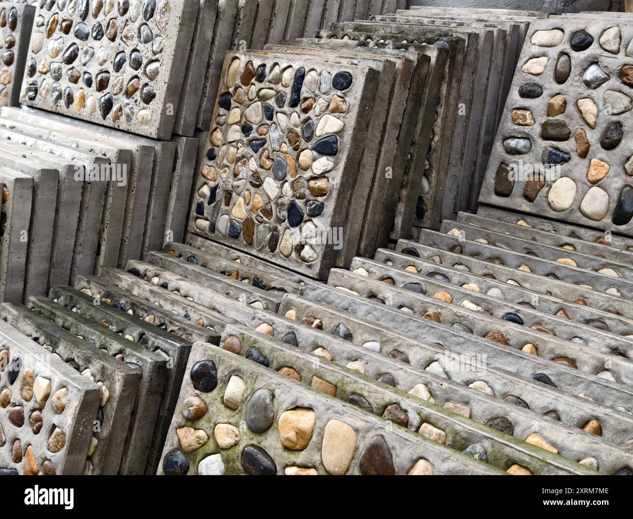 A pile of concrete tiles filled with rocks on top Stock Photo - Alamy