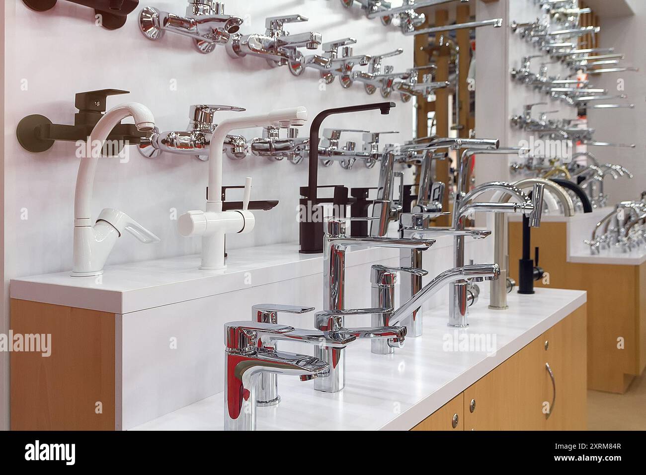 Mixers for kitchen, bathtub, washbasin. Plumbing in a hardware store ...