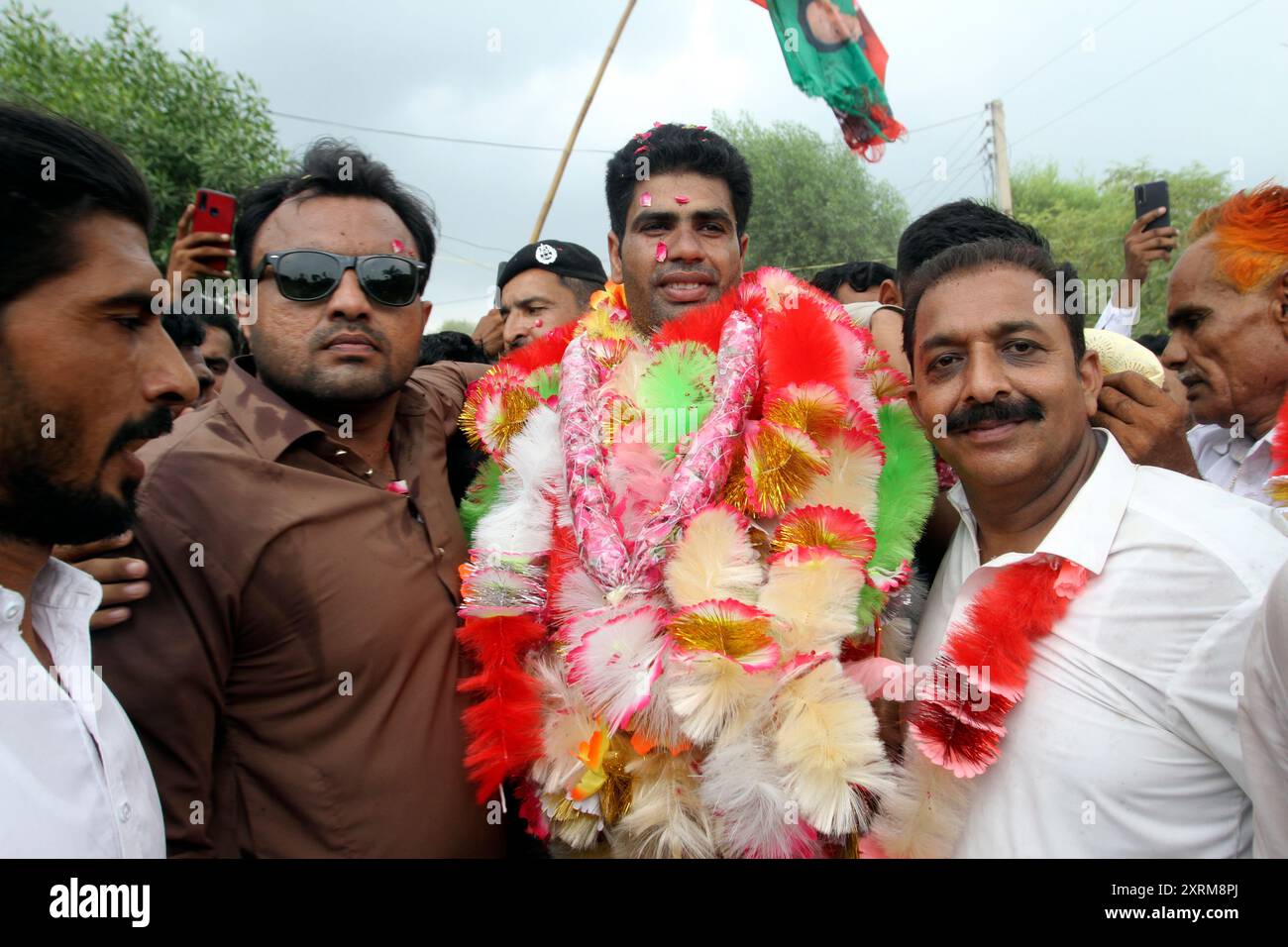 Pakistan's javelin gold medalist, Arshad Nadeem, center, is greeted by ...