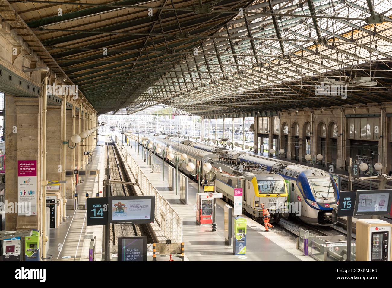 Interior view of Gare Du Nord station, platform and people on concourse ...