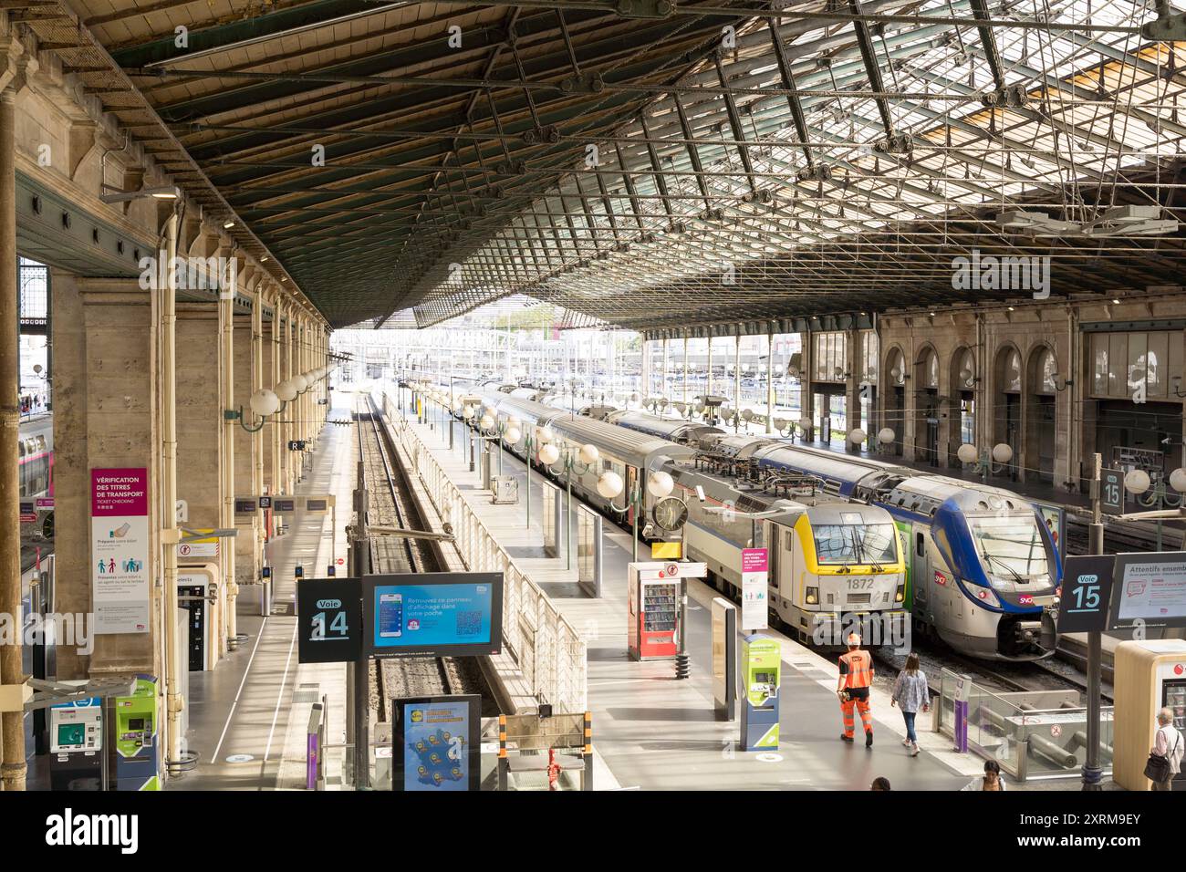 Interior view of Gare Du Nord station, platform and people on concourse ...