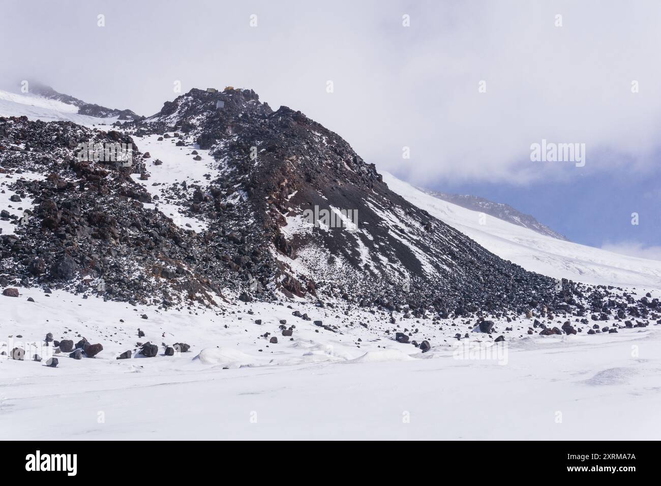 highland mountain landscape, snow-capped basalt rocks on the slope of ...