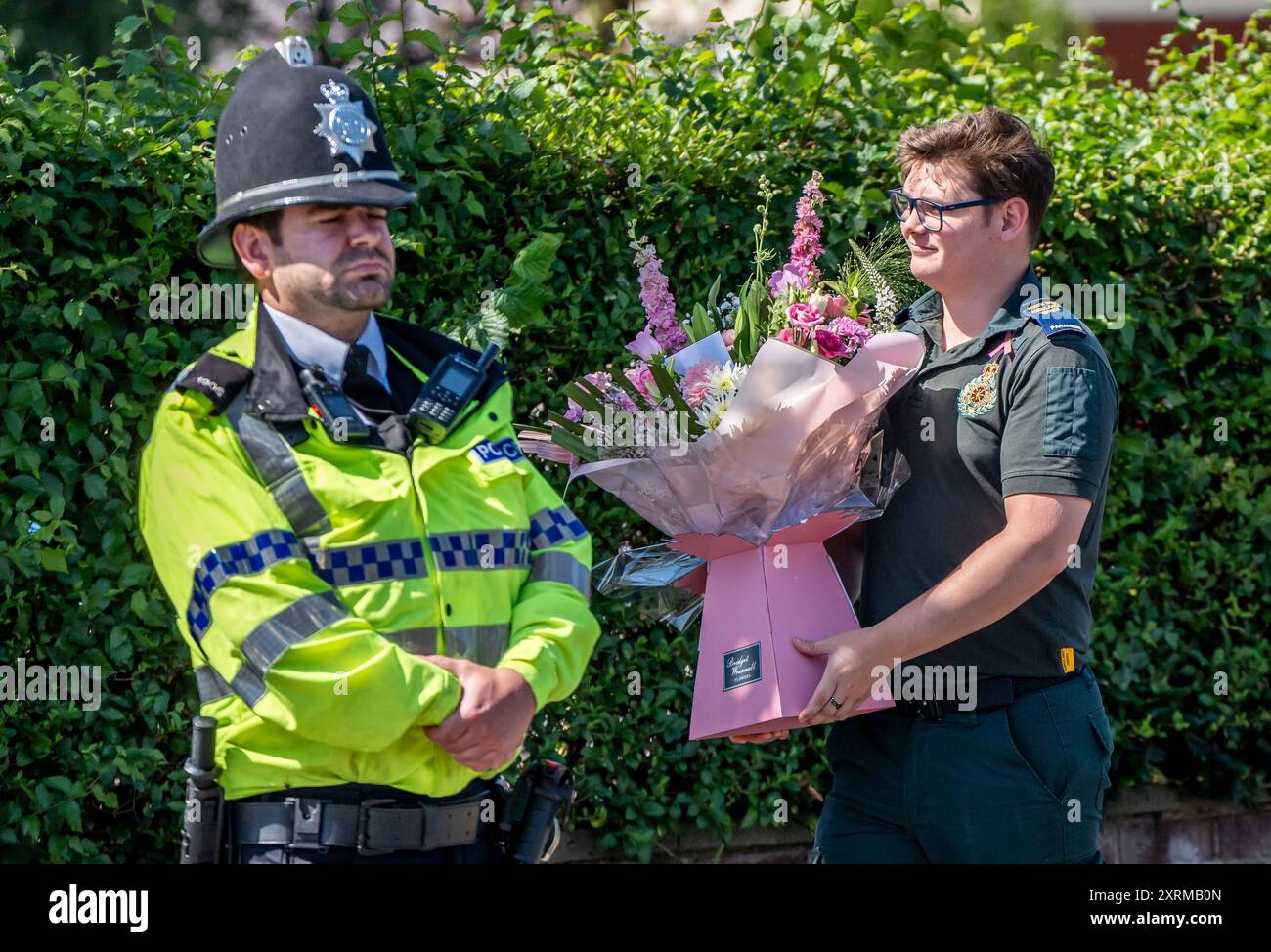 A paramedic carries flowers, ahead of the funeral of Southport stabbing ...