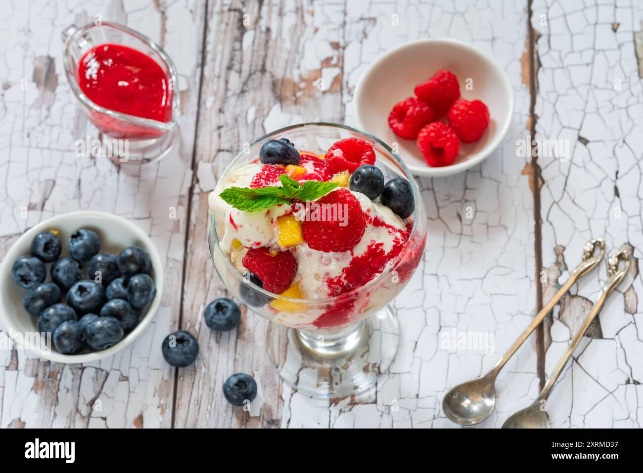 Vanilla ice cream dessert with fresh fruit and raspberry coulis Stock ...