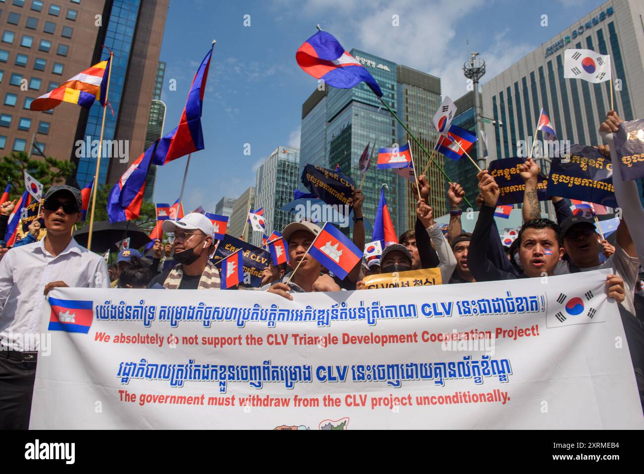 Cambodians living in South Korea are seen holding flags and a banner ...