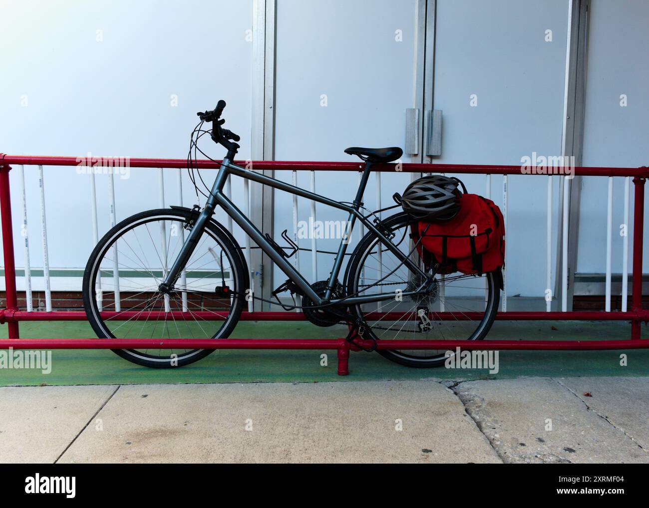A bicycle with touring bags and a helmet locked to a downtown bike rack ...