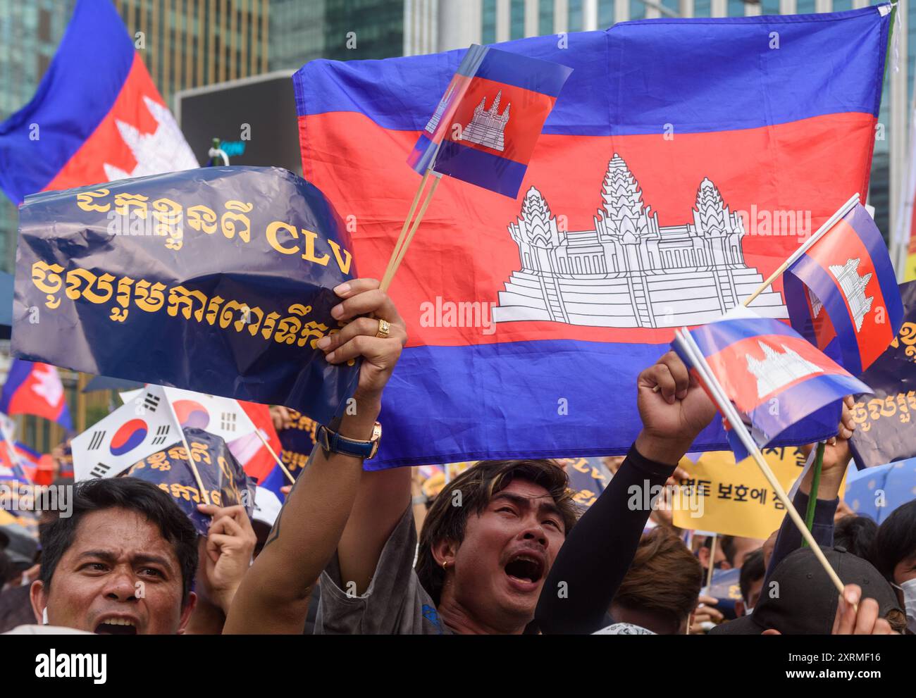 Cambodians living in South Korea are seen holding flags during a ...