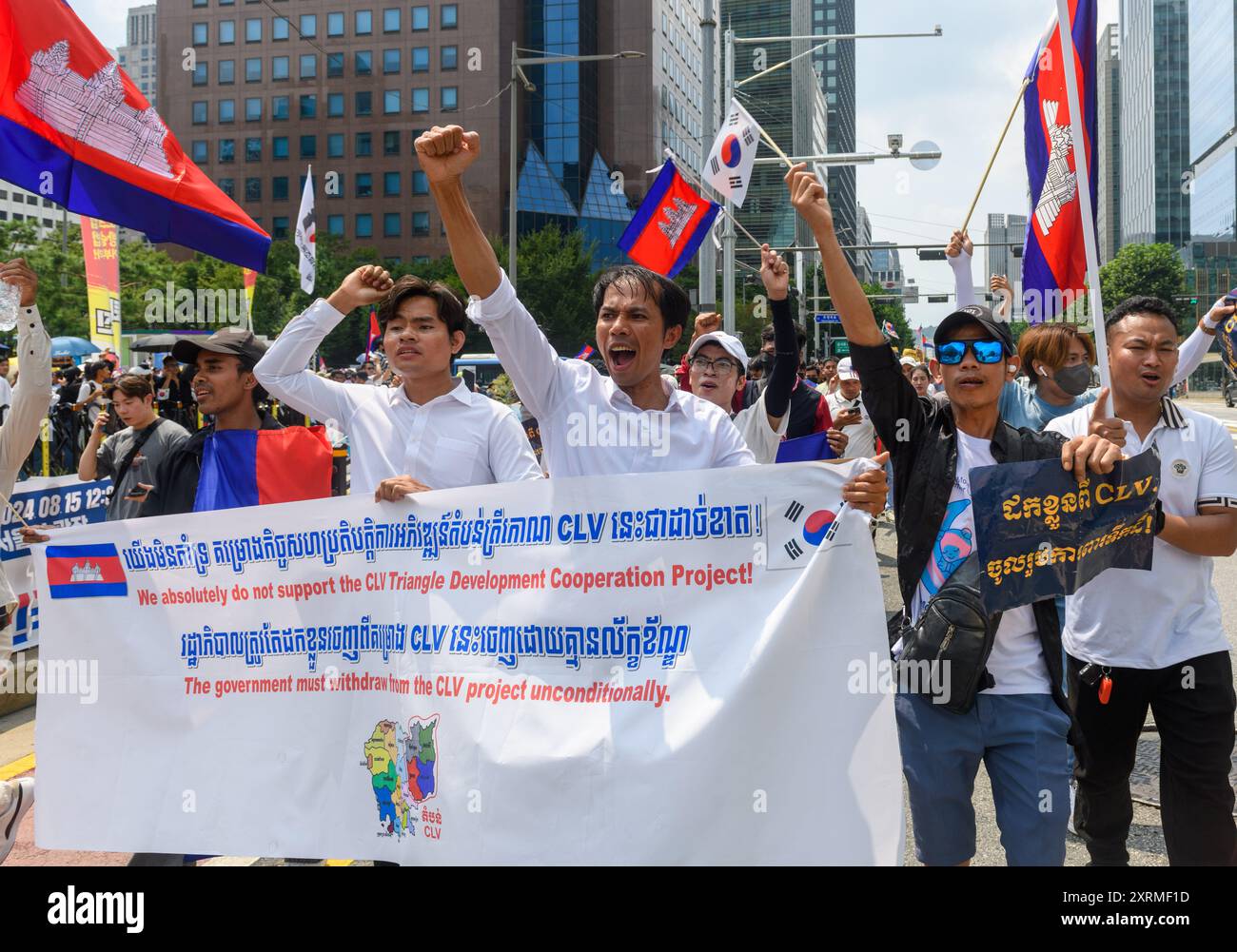 Cambodians living in South Korea are seen holding flags and a banner ...