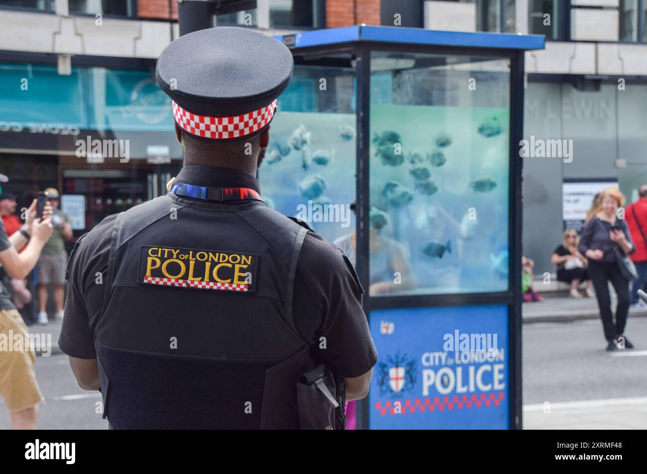 London, UK. 11th August 2024. A police officer observes crowds ...