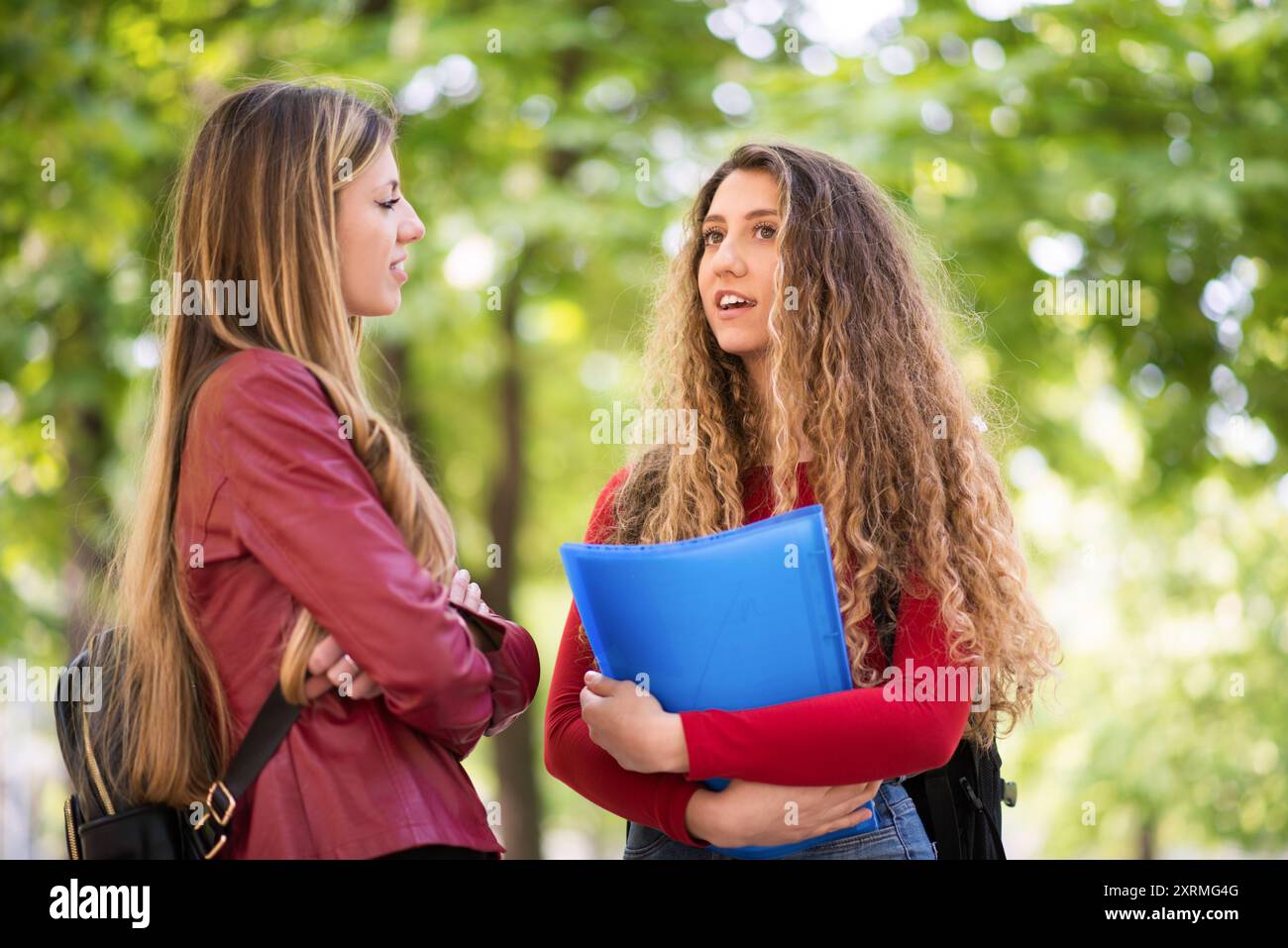 Female students having a conversation outdoor Stock Photo - Alamy