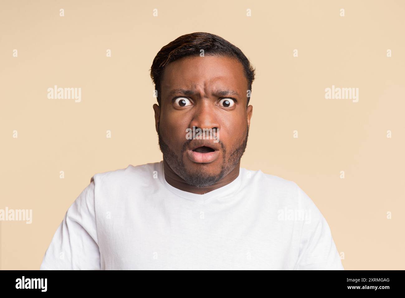 Shocked Afro Man Standing Looking At Camera, Studio Shot Stock Photo ...