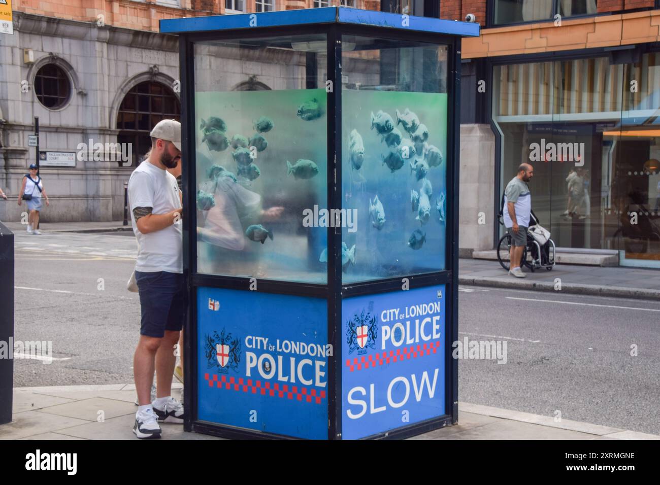 London, UK. 11th August 2024. A man takes photos of the new Banksy ...