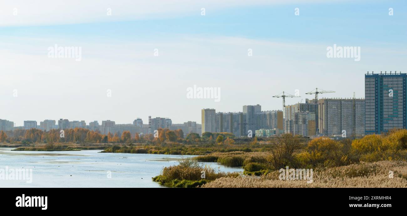 Panorama with river and nature and residential high-rise buildings in ...