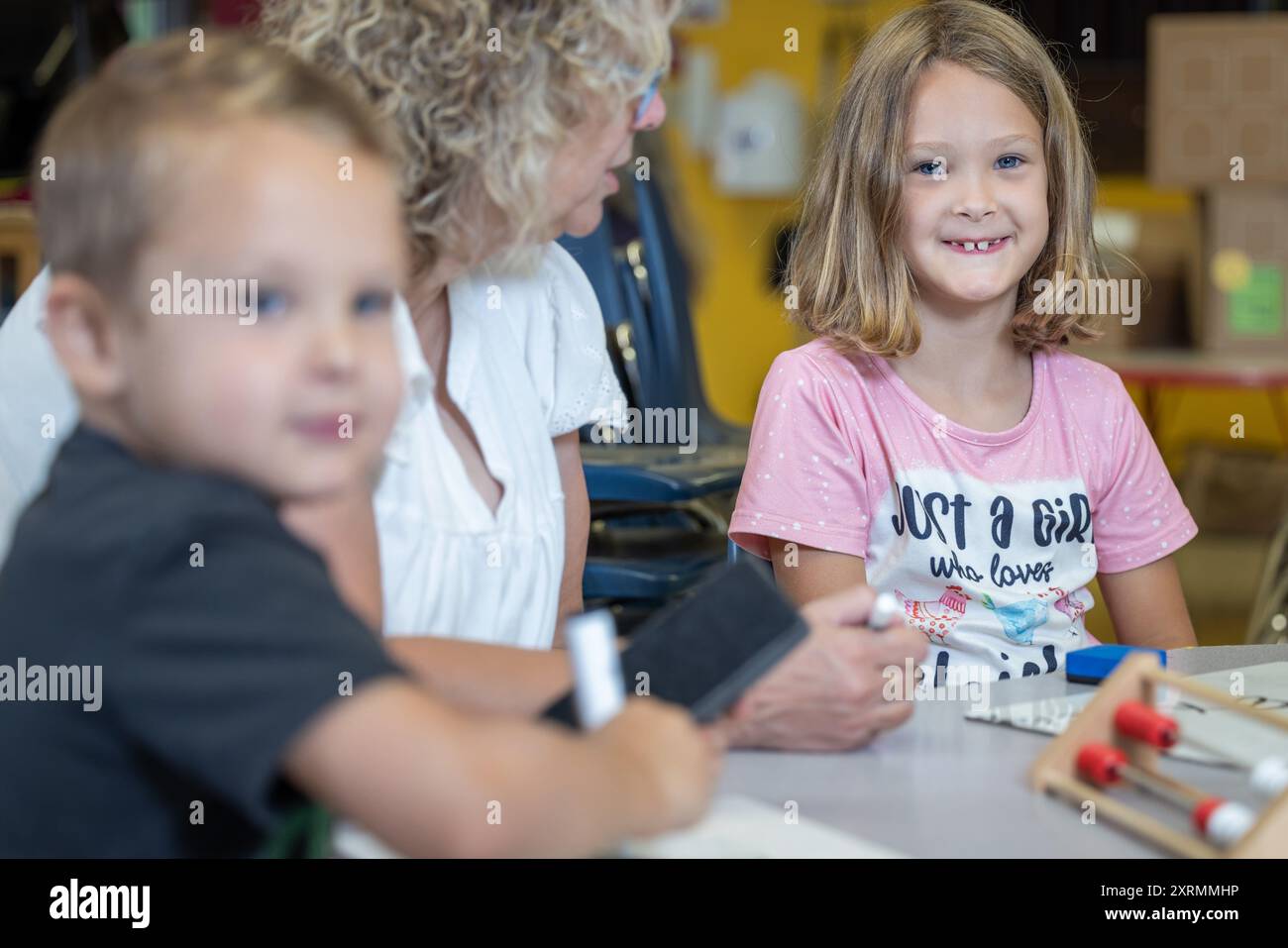 A teacher is helping a child with a math problem. The teacher is ...