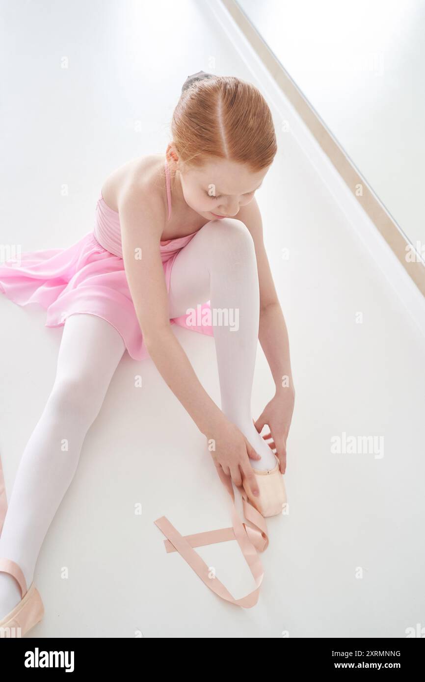 Young ballet girl at studio lesson. Training performance. Stretching ...