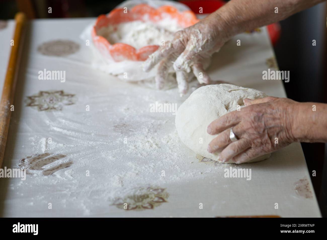 Old woman kneading dough bread hi-res stock photography and images - Alamy