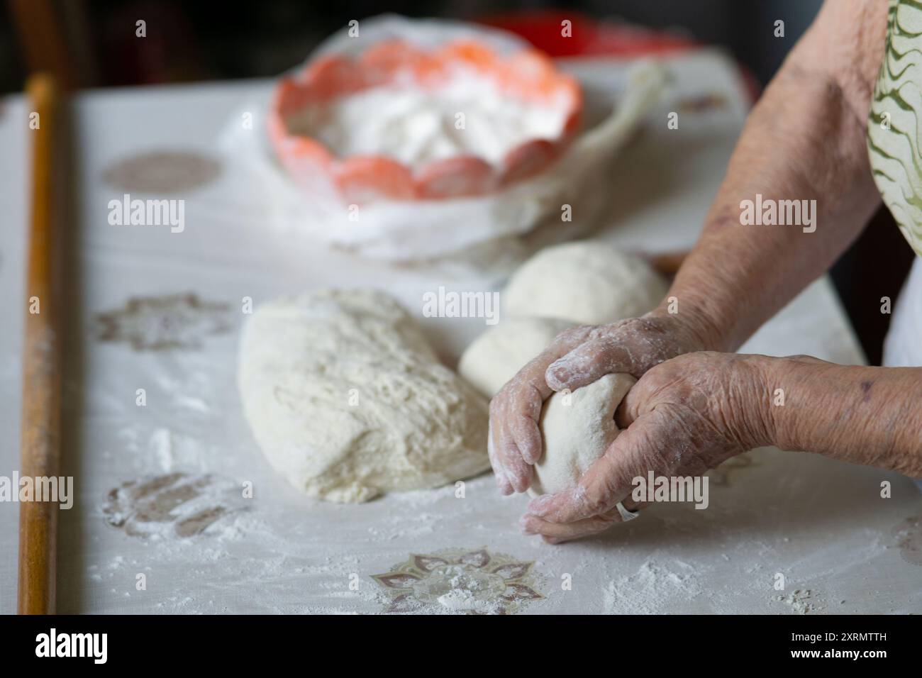 old woman hands kneading bread dough in a plastic bowl Stock Photo - Alamy