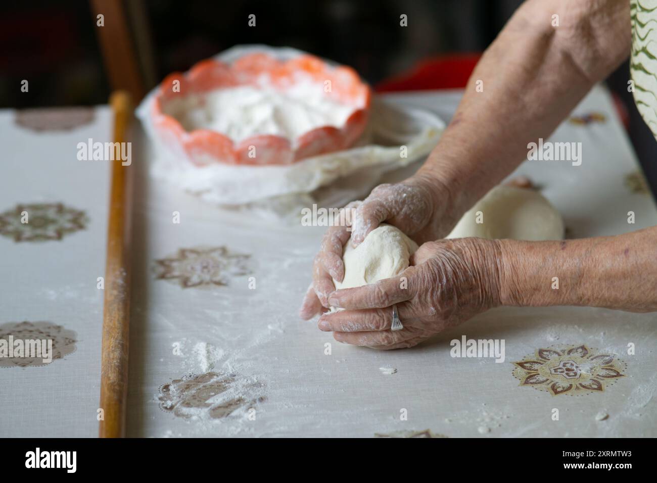 Old woman kneading dough bread hi-res stock photography and images - Alamy