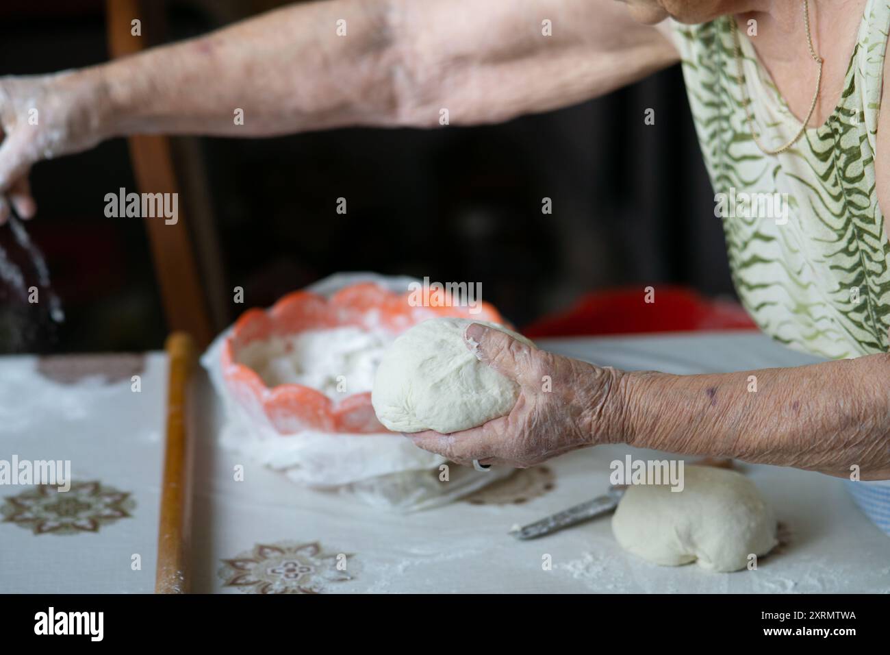 Old woman kneading dough bread hi-res stock photography and images - Alamy