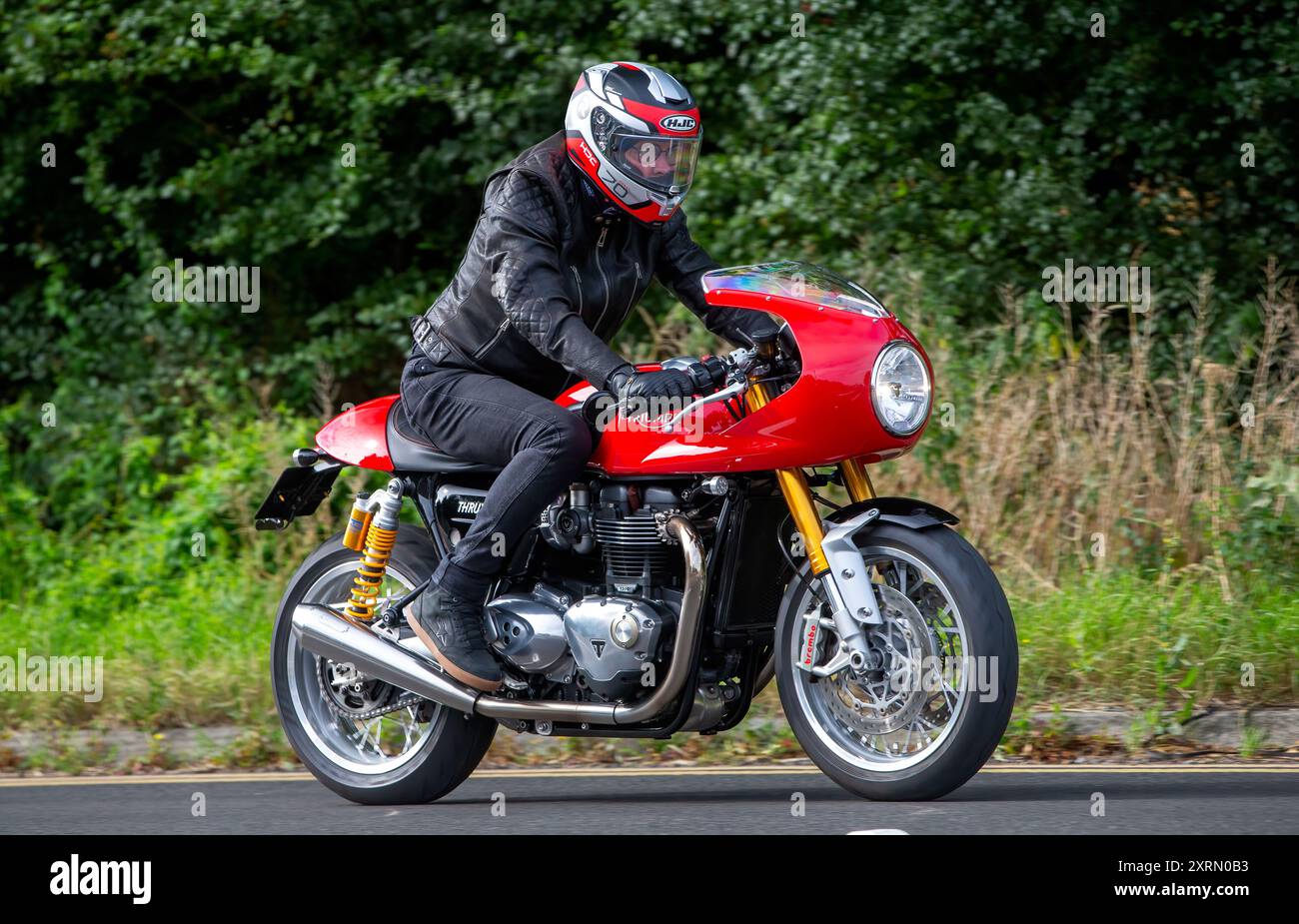 Potterspury,Northants,UK - Aug 11th 2024: Man riding a red 2016 Triumph ...