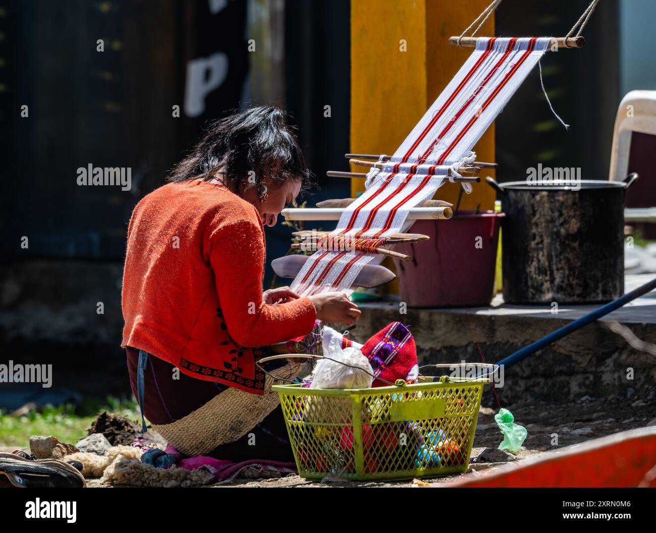 A young indigenous Mayan woman hand weave cloth with backstrap loom in ...
