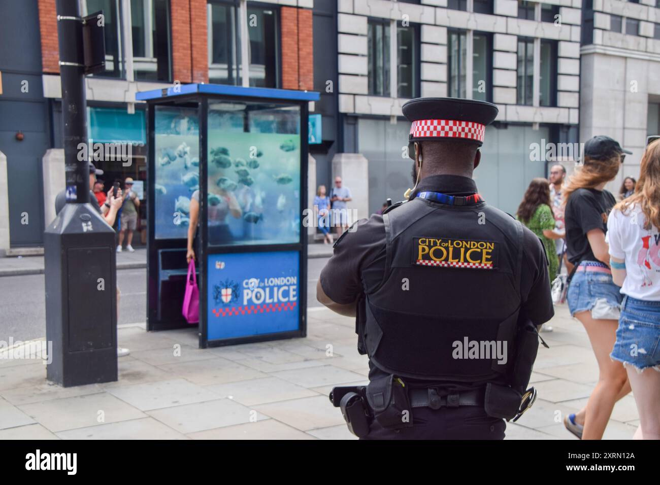 London, England, UK. 11th Aug, 2024. A police officer observes the ...