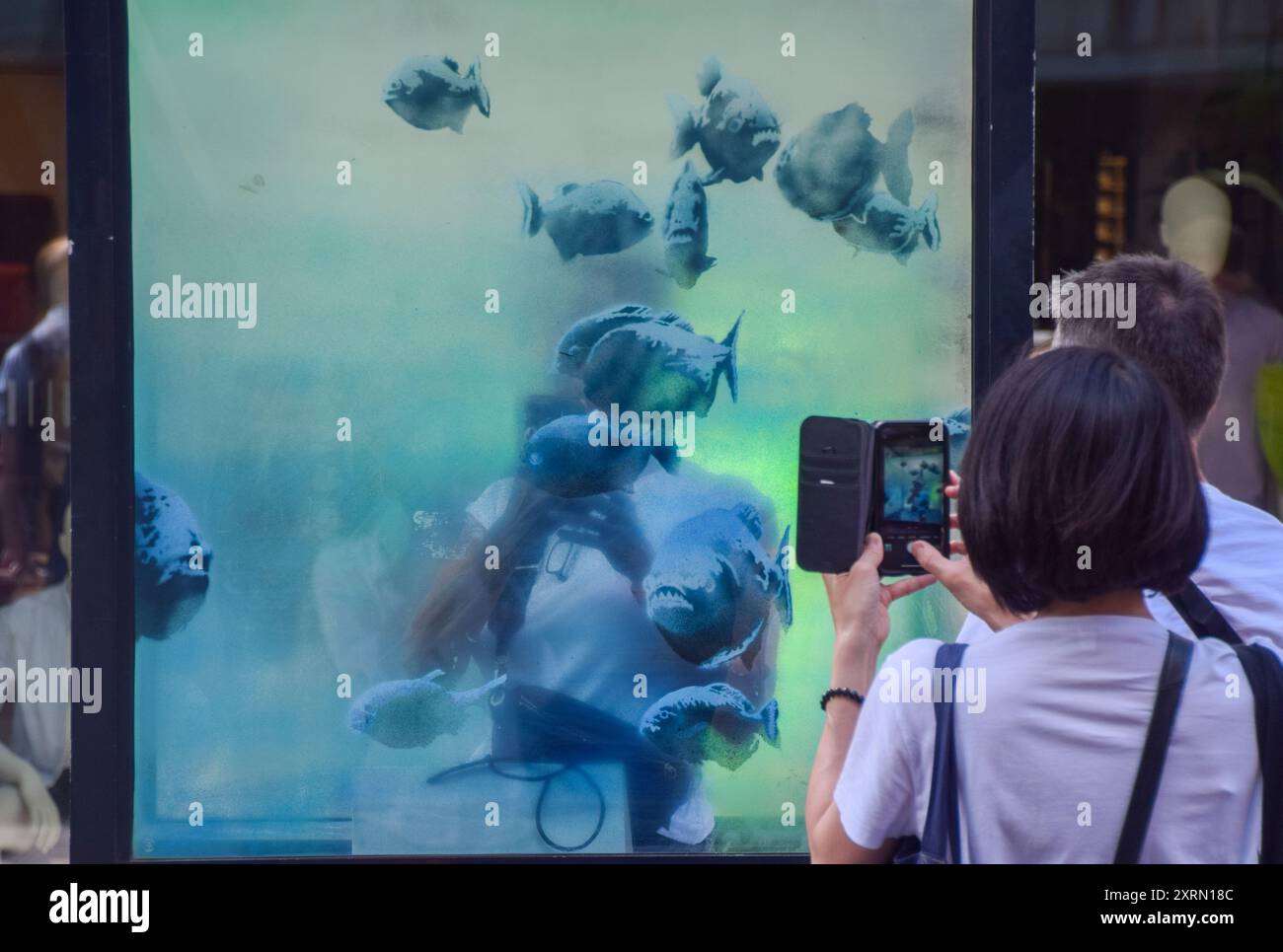 London, England, UK. 11th Aug, 2024. A woman takes photos of the new ...